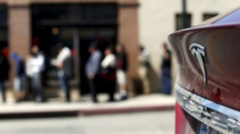 Tesla fans camp out, form long lines to sign up for new Model 3