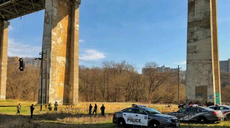 Mystery car dangling from a bridge leaves people in Toronto perplexed