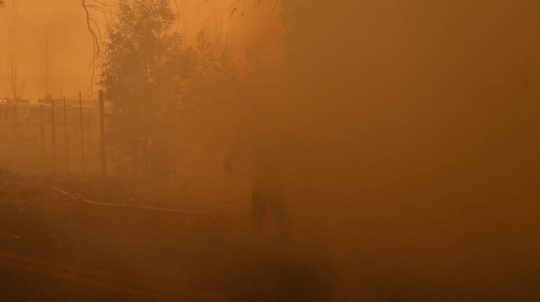 Firefighters struggle against massive, wind-whipped California wildfire