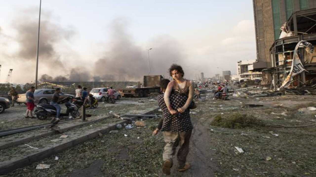 Smoke rises in the aftermath of a massive explosion in Beirut, Lebanon ...
