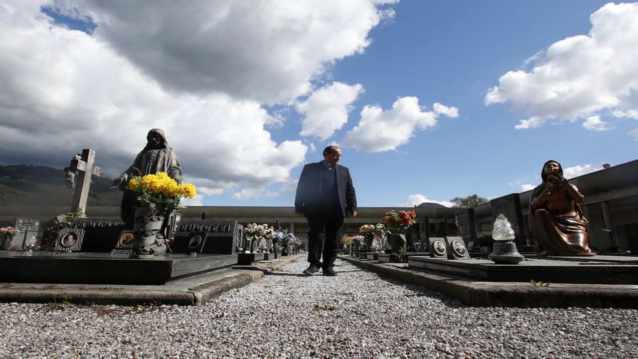 In pictures: At coronavirus milestone, Italian priest reflects on loss ...