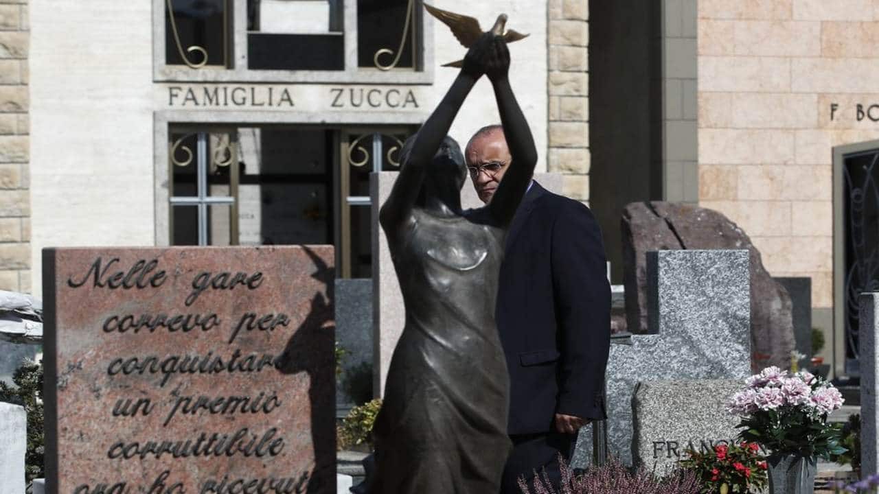 In pictures: At coronavirus milestone, Italian priest reflects on loss ...