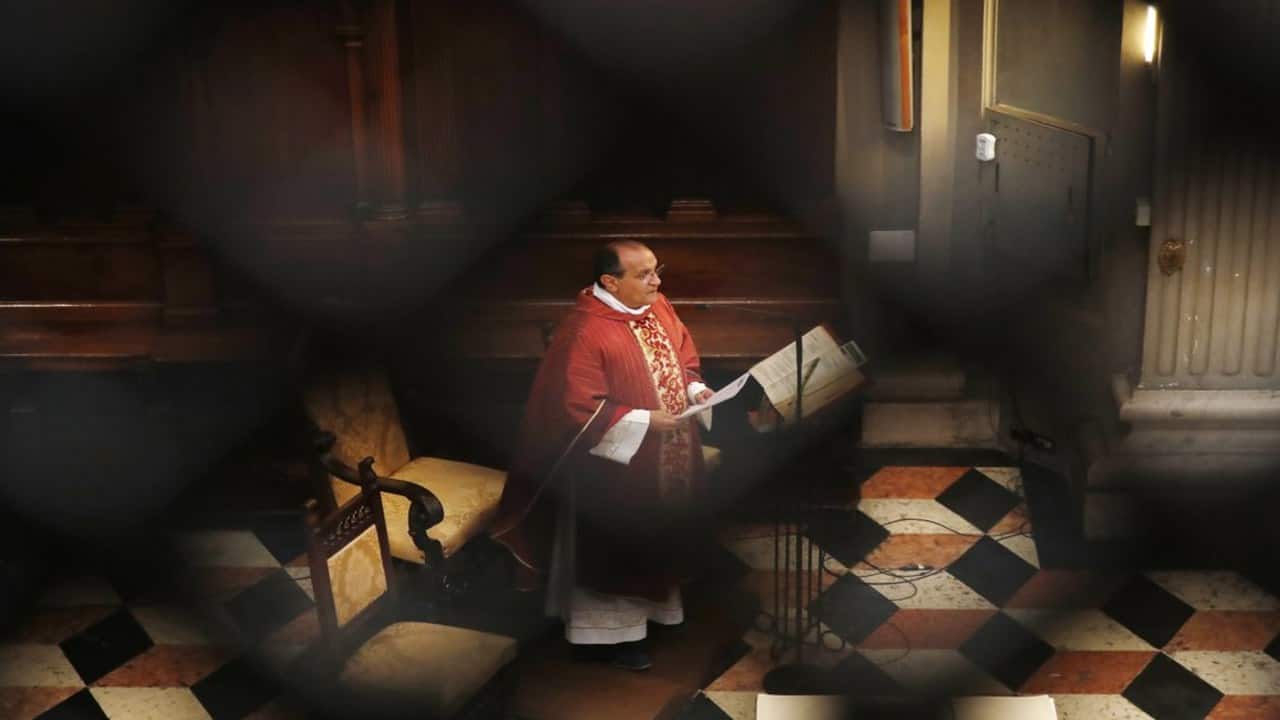 In pictures: At coronavirus milestone, Italian priest reflects on loss ...