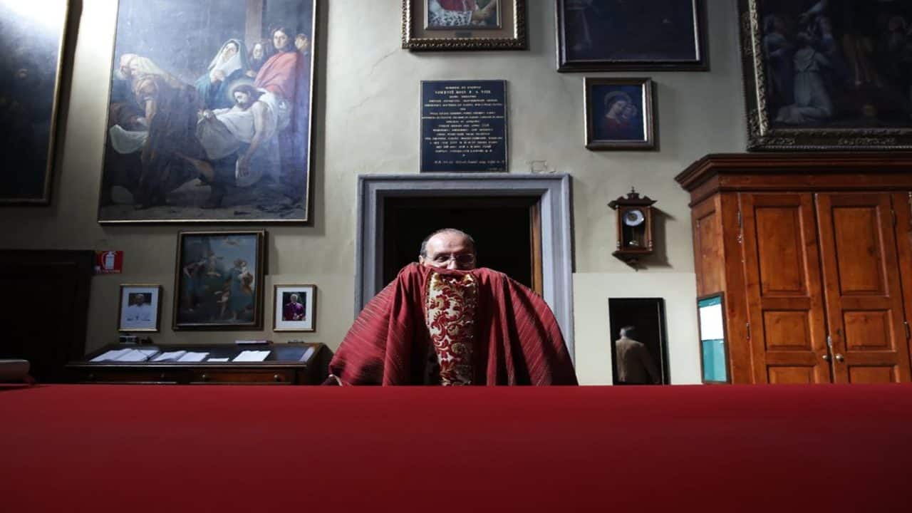 In pictures: At coronavirus milestone, Italian priest reflects on loss ...
