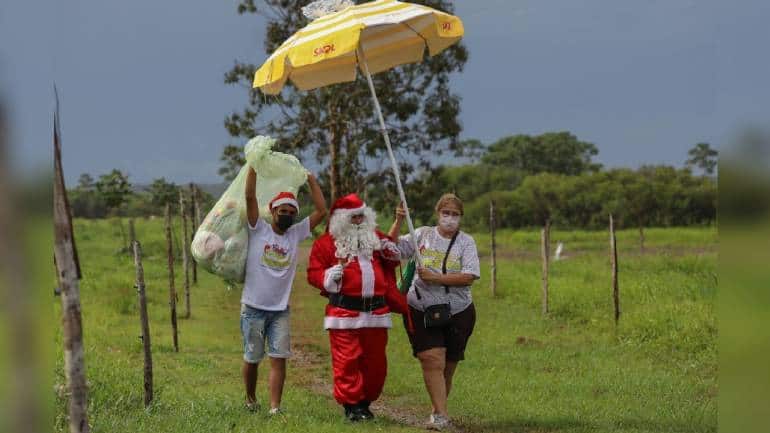 In Brazil's sweltering Amazon, Santa swaps his sled for boat