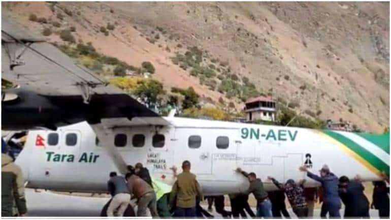 Watch: Bizarre video shows passengers pushing plane off Nepal airport ...