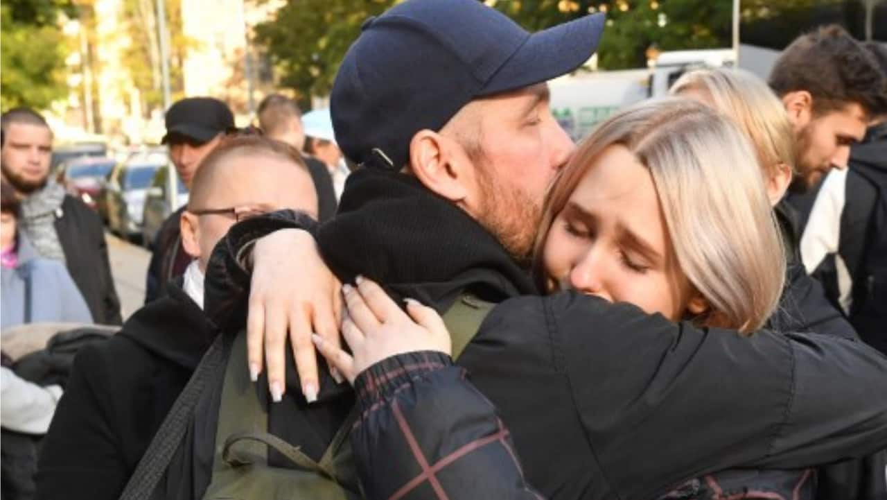 One last hug: Russian women bid farewell to men after Putin's military ...