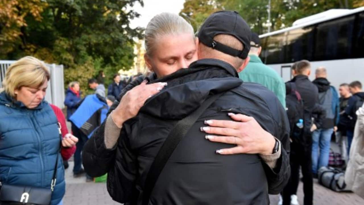 One last hug: Russian women bid farewell to men after Putin's military ...