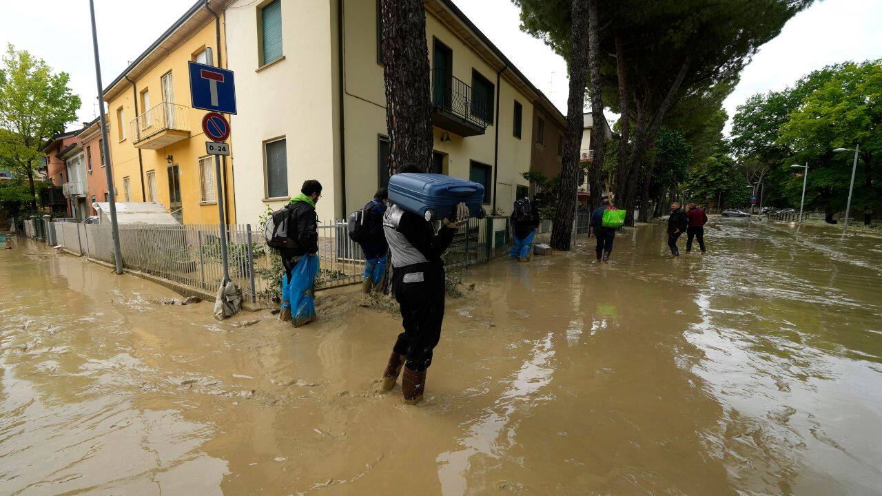 In Pics: Rescue workers reach Italian towns isolated by floods as death ...