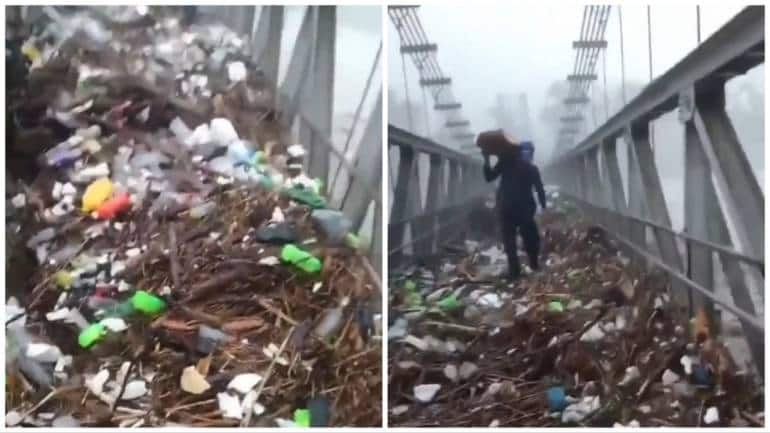 River regurgitates heaps of trash on bridge after heavy rainfall ...