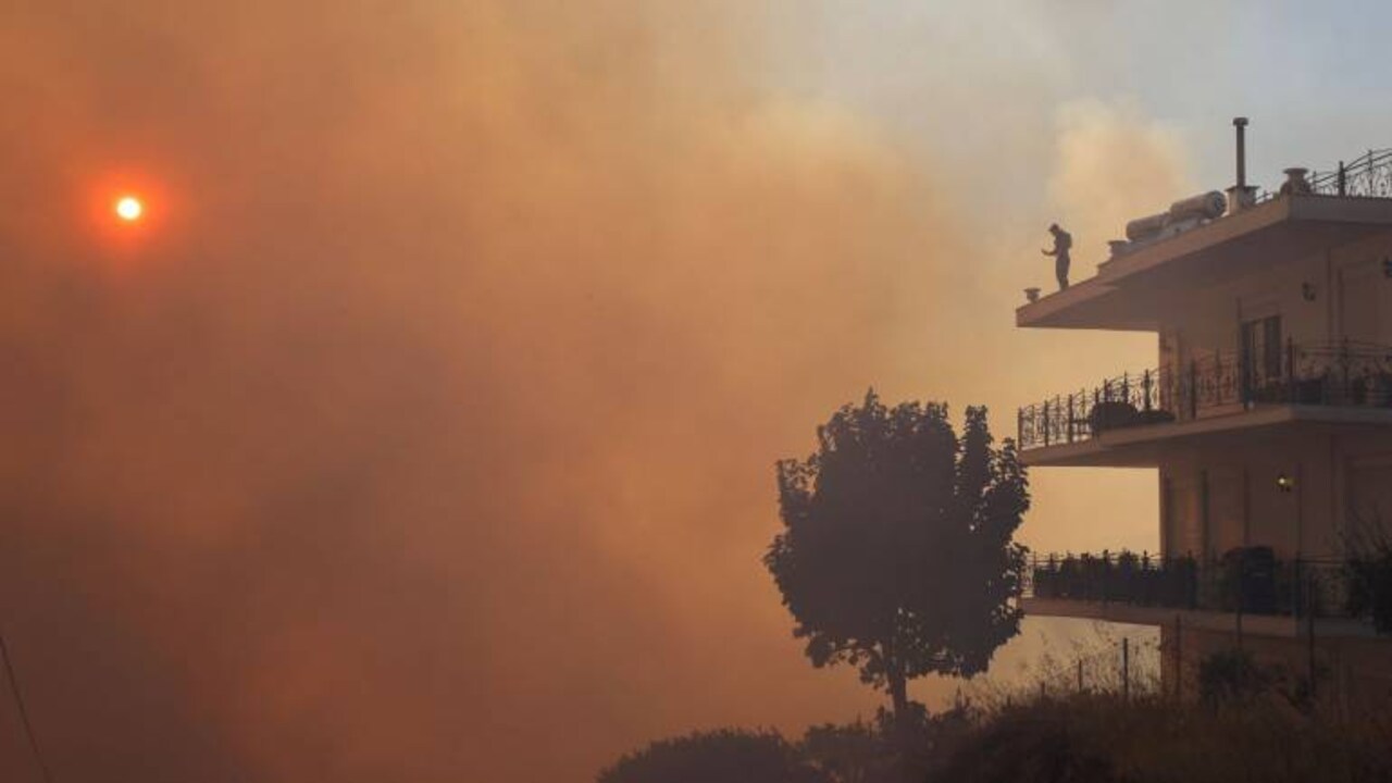 In Pics: Wildfire in Athens forces thousands to flee towns ...