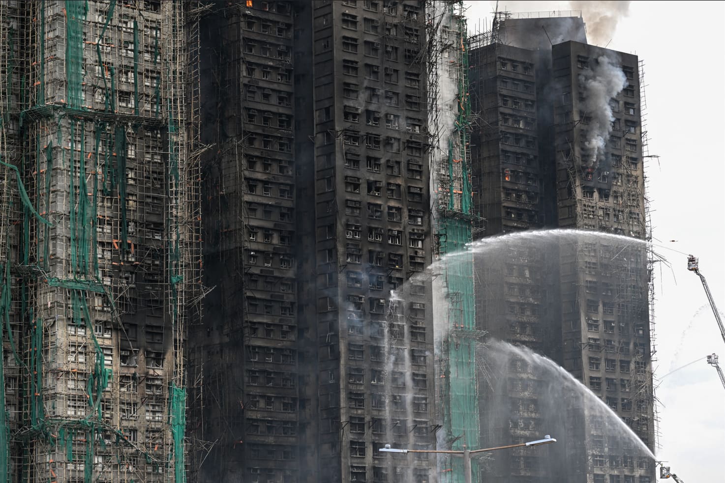 Hong Kong high-rise fire: 55 dead as crews battle remaining flames